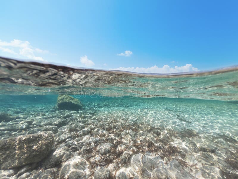 Split Underwater View of a Seabed with Rocks and Sand Stock Photo ...