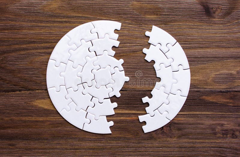 Split White Round Puzzle Set on a Wooden Background Stock Image - Image ...