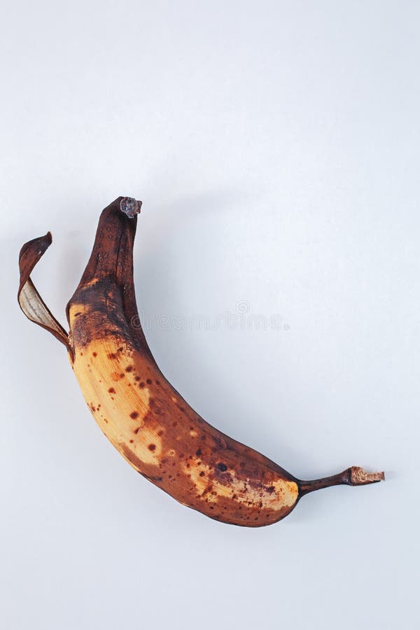 Spoiled Banana and Rotten Persimmons on a Color Monochrome Background ...