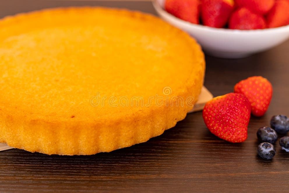 Sponge Cake on the Table. the Process of Making Strawberry Pie Stock ...