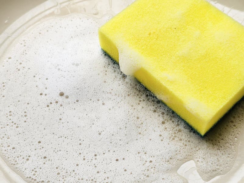 Sponge and Dishwashing Liquid on a Plate. Closeup Side View Stock Image ...