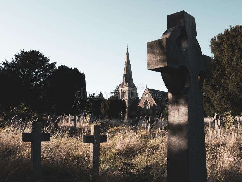 A Spooky, Eerie, Overgrown Graveyard with a Church in the Background ...