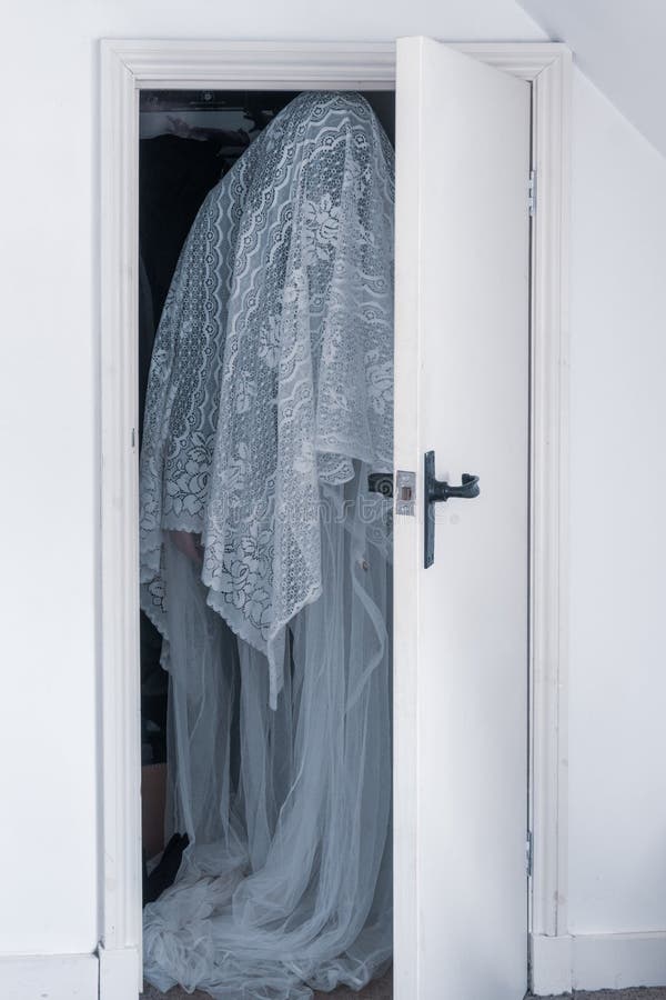 A Spooky Ghost with a Sheet Over Them. Standing in a Closet Stock Photo ...