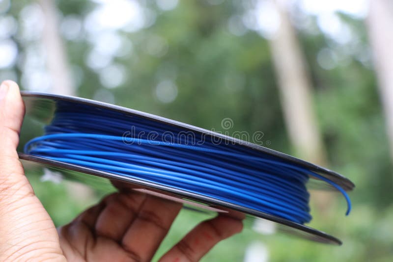 Spool of Blue Color Wire Called As 3D Printer Filament Held in Hand on ...