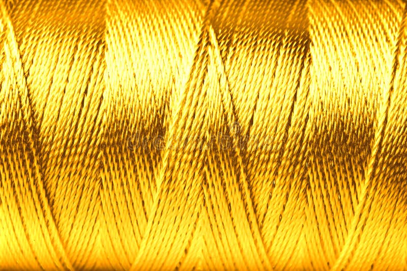 Spool of Golden Sewing Thread As Background, Closeup Stock Photo ...