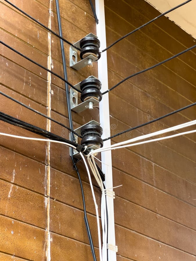 The Spool Insulators in the Electric Wire System on the Building Wall ...