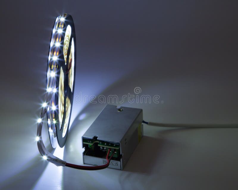 Spool of Luminous LED Strip Light Connected To Power Supply. Stock ...
