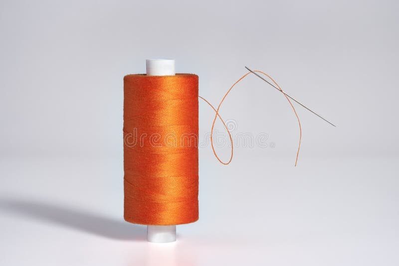 Spool of Orange Threads with a Needle Levitate on White Background ...