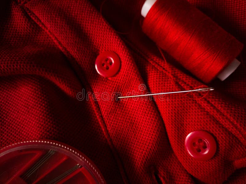 Red Thread and a Sewing Needle on Textured Red Fabric Stock Image ...