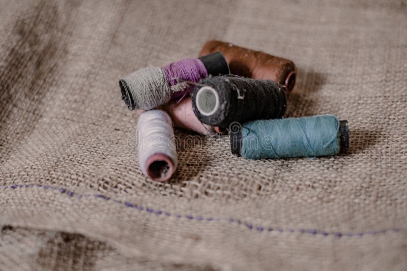 Spool of Sewing Thread on Brown Fabric Stock Photo - Image of clothing ...