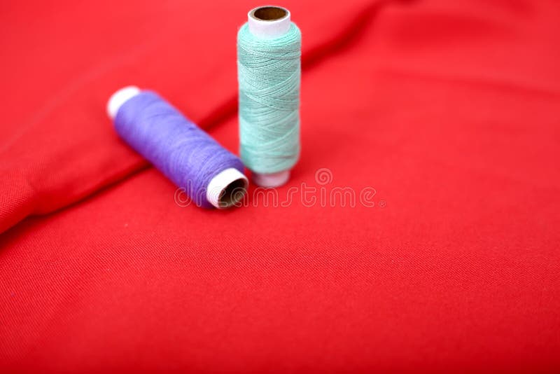 Spool of Sewing Thread on the Red Cloth Stock Photo - Image of ...