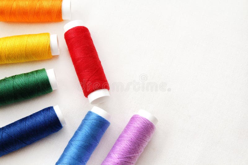 Spool of Sewing Threads Multicolored on White Cotton Fabric with Copy ...
