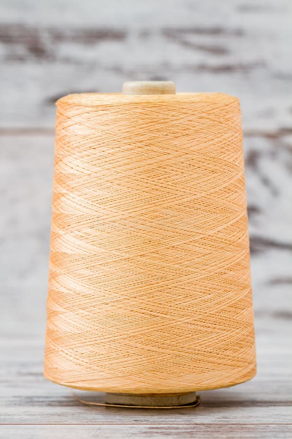 Spool of Synthetic Orange Thread on White Wooden Background Stock Image ...