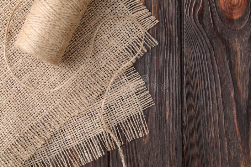 Spool of Thread and Burlap Fabric on Wooden Table, Top View. Space for ...