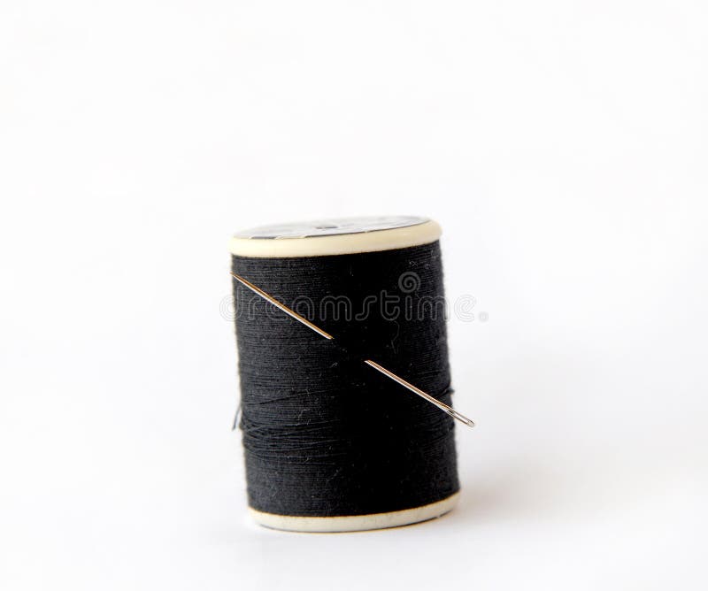 Spool of Thread with a Needle Closeup on White Background Stock Image ...
