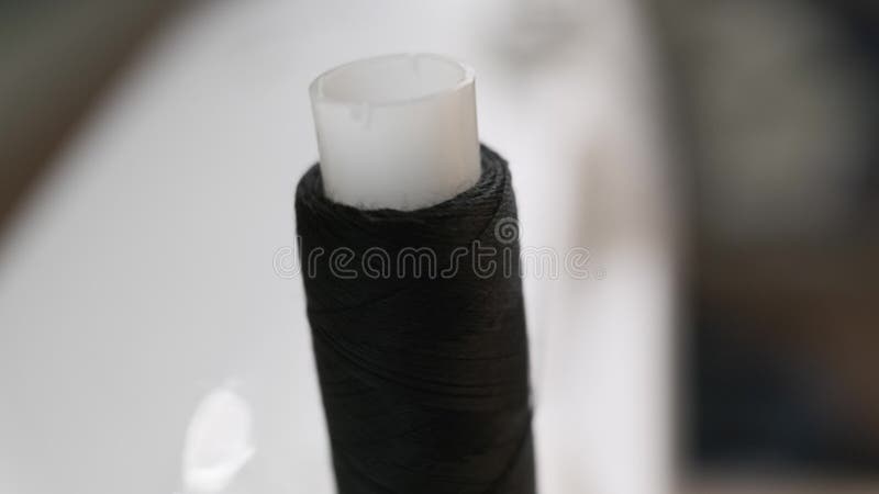 The Spool of Thread on the Sewing Machine is Unwound in the Process of ...
