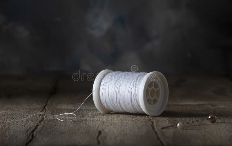 Spool of White Thread on a Wooden Table Stock Photo - Image of wood ...