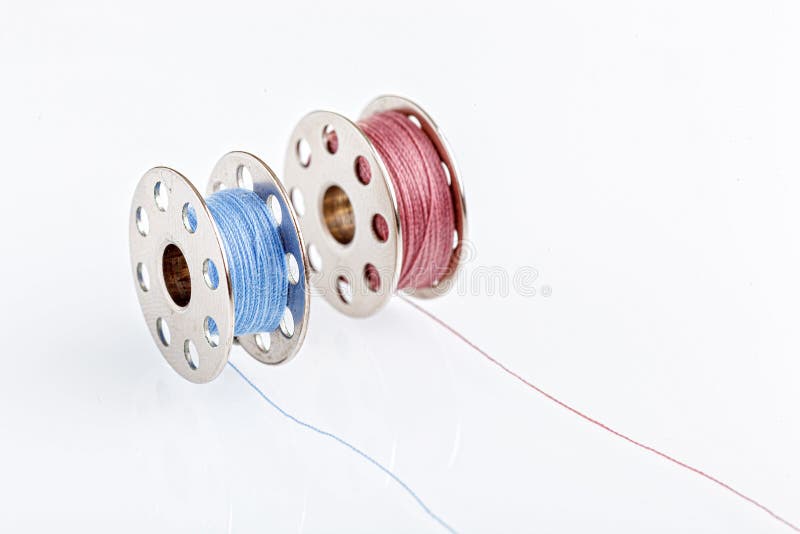 Spools of Blue and Pink Thread on a White Background Stock Photo ...