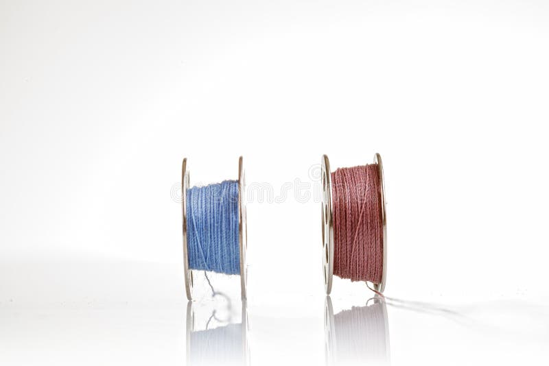Spools of Blue and Pink Thread on a White Background Stock Image ...