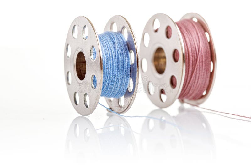 Spools of Blue and Pink Thread on a White Background Stock Image ...