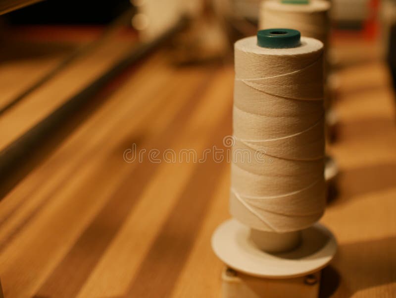 Spools of Thread Display on Wood Table in Factory Stock Photo - Image ...