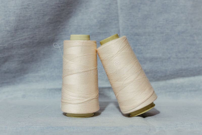 Spools of Thread, One in a Pale Blue Fabric Stock Photo - Image of ...