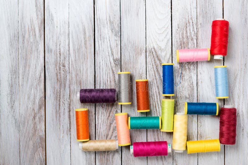 Spools of Threads on White Wooden Background. Stock Image - Image of ...