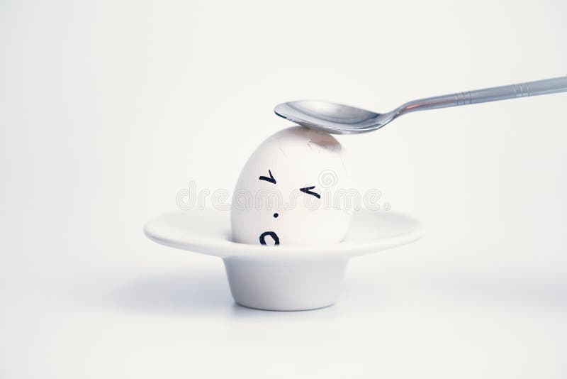 Spoon Breaks Sad Egg on a Stand in the Form of Human Head . Stock Image ...