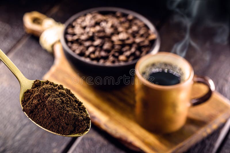 Spoon with Coffee Powder and Cup with Hot Coffee in the Background ...