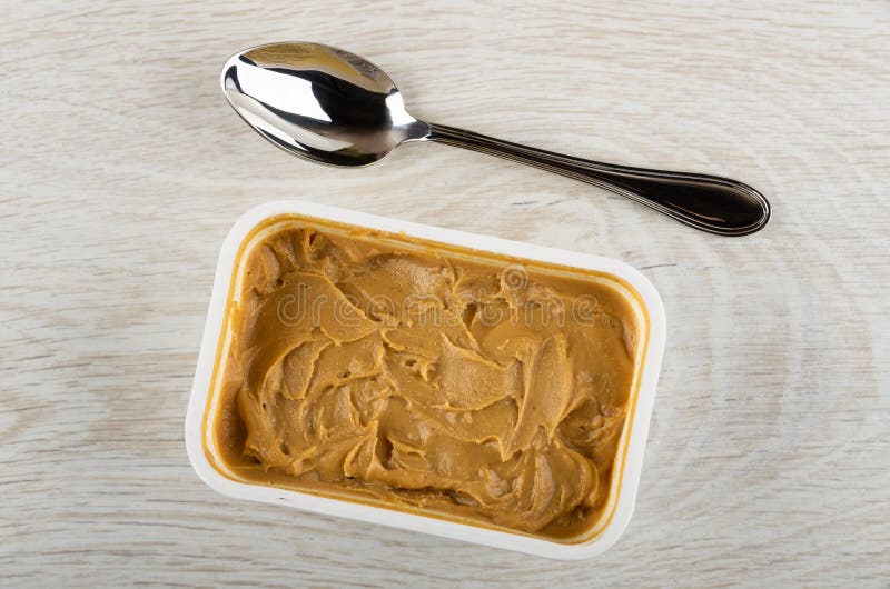 Spoon, Container with Peanut Butter on Wooden Table. Top View Stock ...