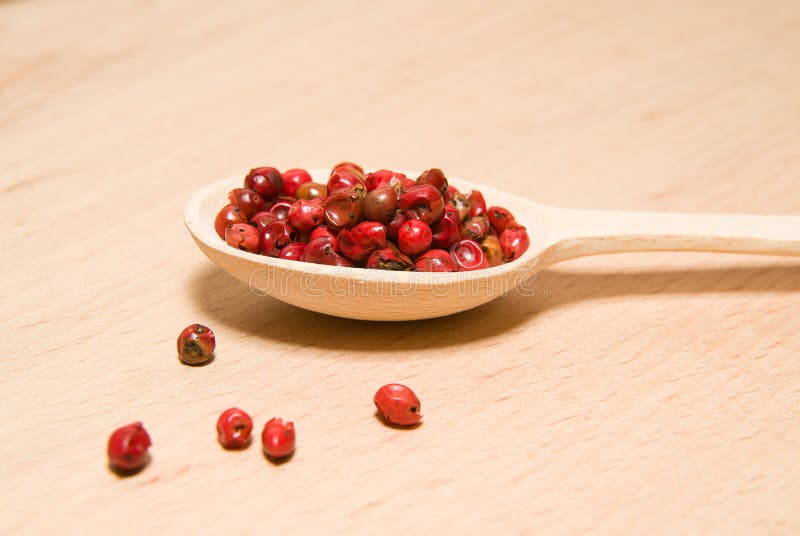 Spoon Filled with of Grains of Pepper on a Wooden Surface Stock Image ...