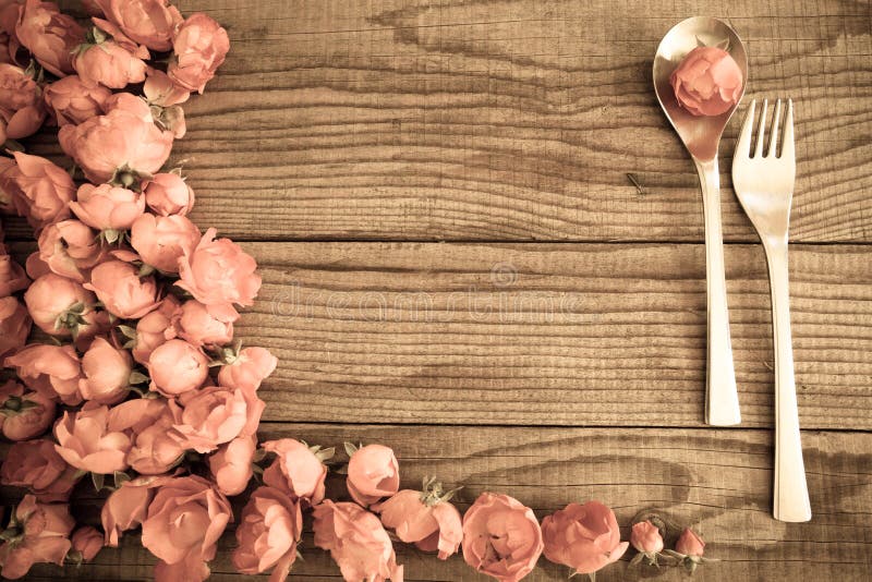 Spoon and Fork Over a Wooden Table with Red Roses Stock Image - Image ...