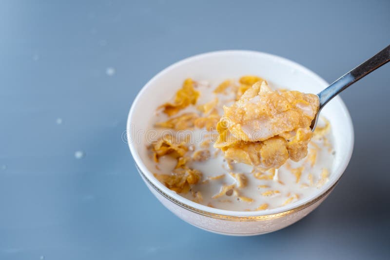 A Spoon Lifting a Portion of Crispy Cornflakes Soaked in Milk from a ...
