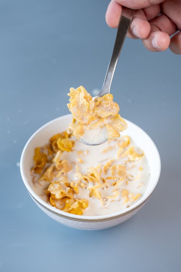 A Spoon Lifting a Portion of Crispy Cornflakes Soaked in Milk from a ...