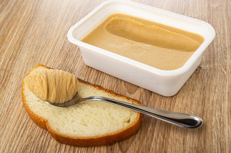 Spoon with Peanut Butter on Slice of Bread, Box with Peanut Paste on ...