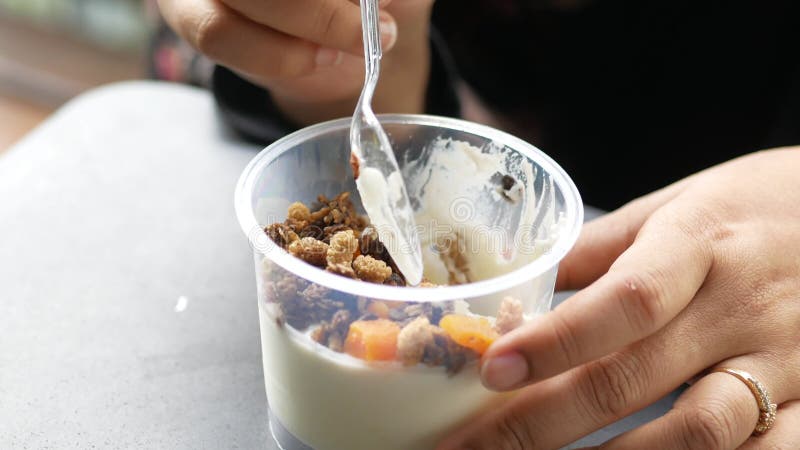 Spoon Pick Breakfast Cereal from a Plastic Container Outdoor Stock ...