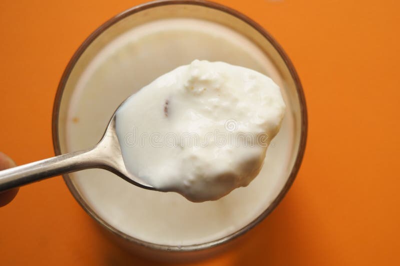 Spoon Pick Fat Cream from a Glass of Milk Stock Photo - Image of ...