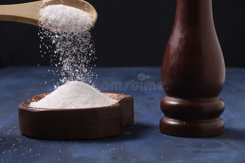 A Spoon of Salt Falling Down into a Pot Stock Photo - Image of glasses ...