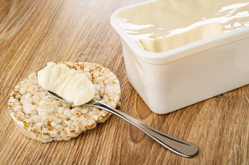 Spoon with Soft Cheese on Crispbread, White Container with Cream Cheese ...
