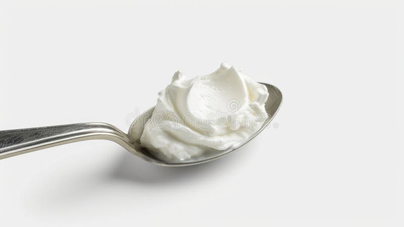 A Spoonful of Whipped Cream Sits on a Clean White Surface, Ready for ...