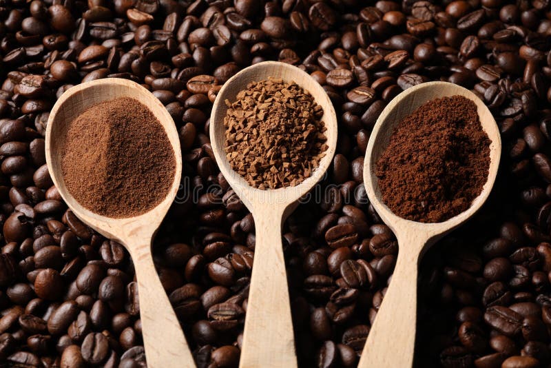 Spoons with Different Types of Coffee on Roasted Beans, Above View ...
