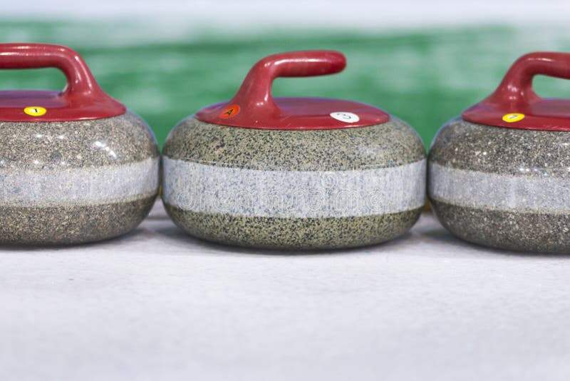 Sport Concepts. Closeup of Curling Blue Handle Stones on Ice Stock ...
