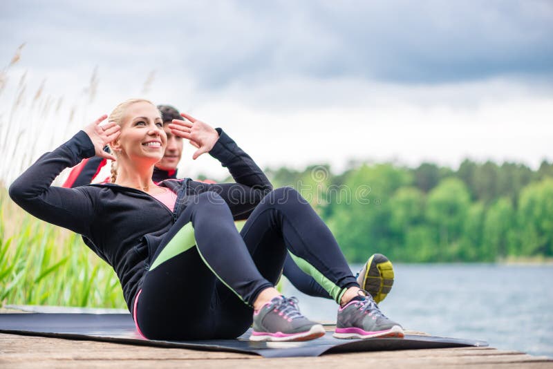 Sport Couple Doing Sit-ups Outdoor at River Stock Image - Image of ...