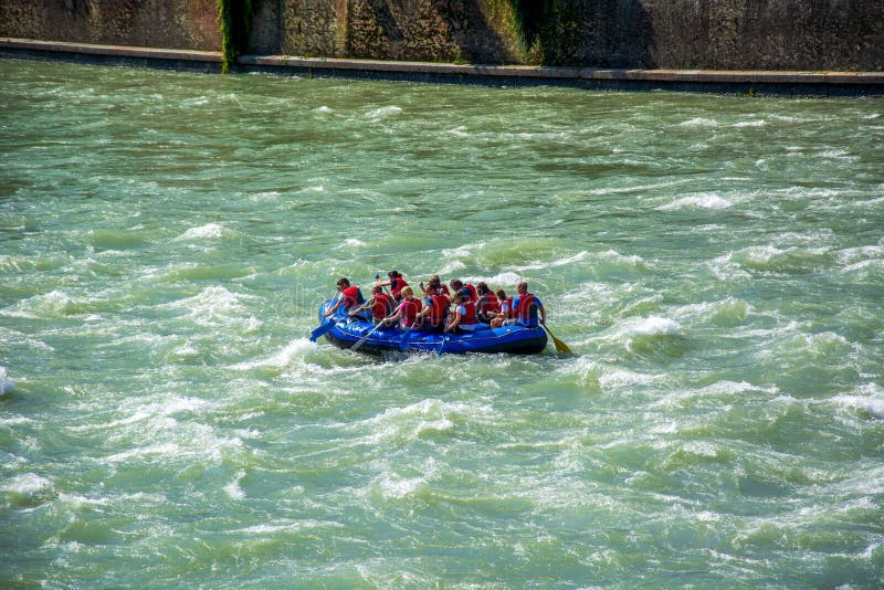 A Group of Daring People Challenge the Rapids of the Adige River ...