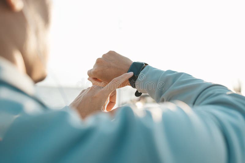 Sport Man Checking at Smartwatch during Training and Running in the ...