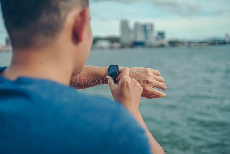 Sport Man Checking at Smartwatch during Training and Running in the ...