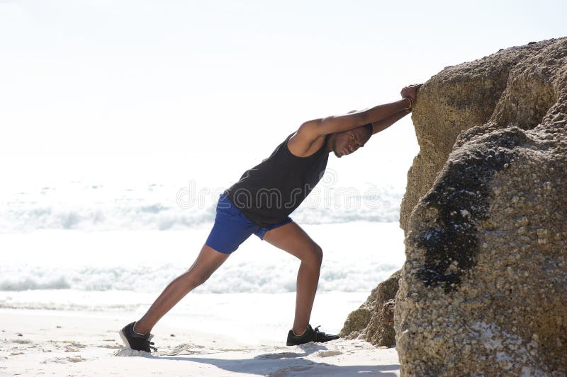 Sport Man Pushing on Rock at the Beach Stock Photo - Image of male ...