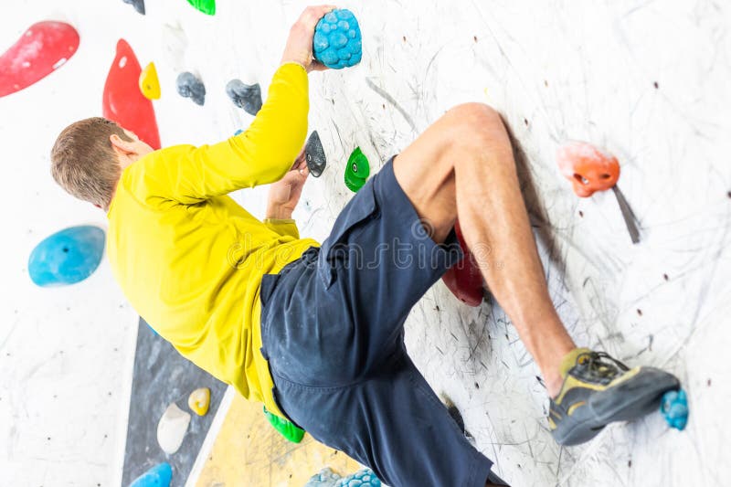 Sportive Man Climbing the Boulder Wall in a Climbing Centre, Sport ...