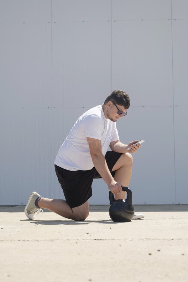 Sportive Man Workout with Kettlebell Outdoor in Spring or Summer Stock ...