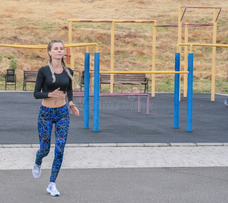 Sports Girl Doing Exercises on the Buttocks on the Playground. Stock ...